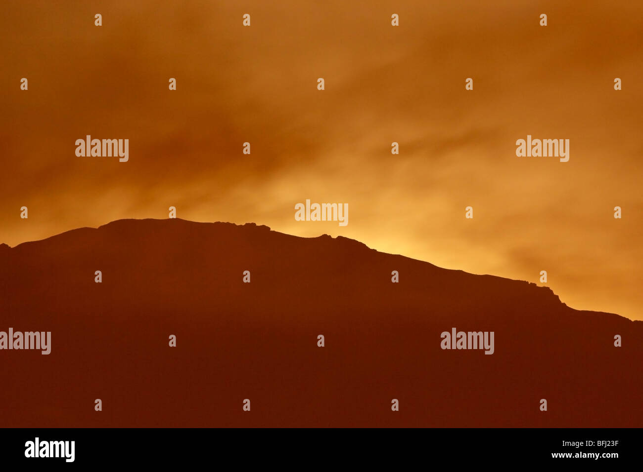 The moon sets behind a mountain in Cuenca, Ecuador Stock Photo - Alamy