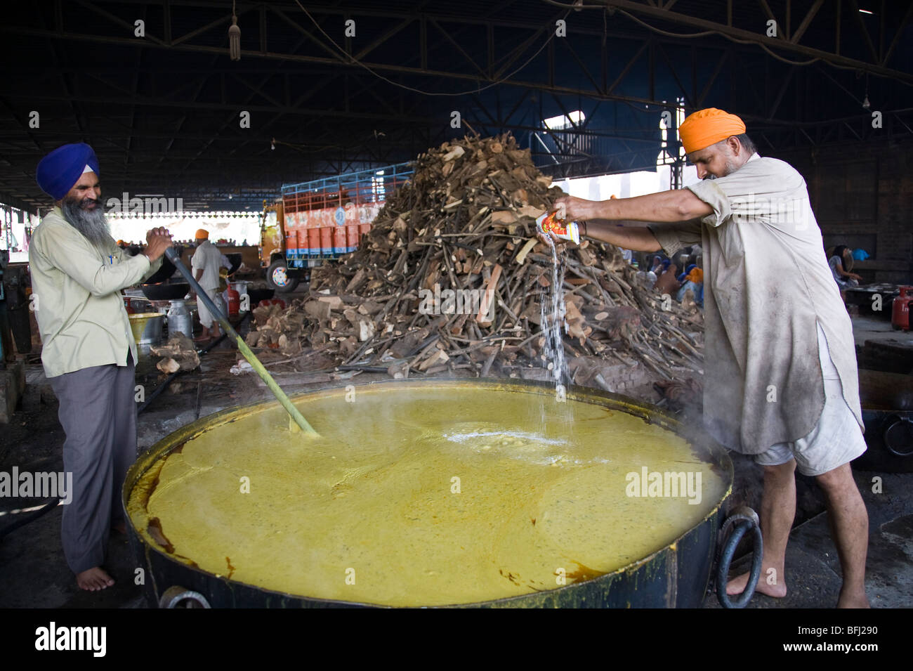Sikhs men cooking dhal (curried lentils) in a big pan. The Golden ...