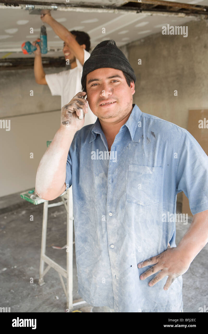 Portrait of construction worker using mobile phone Stock Photo - Alamy