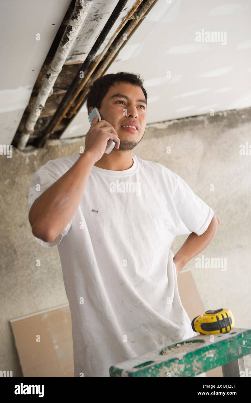 Construction worker using mobile phone Stock Photo - Alamy