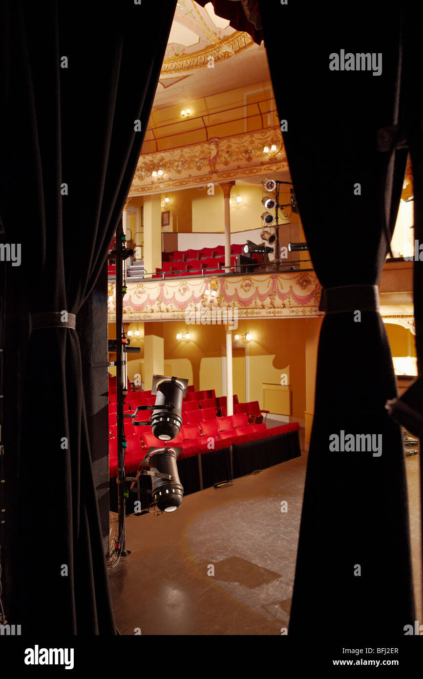 Theatre, view through stage curtain Stock Photo - Alamy