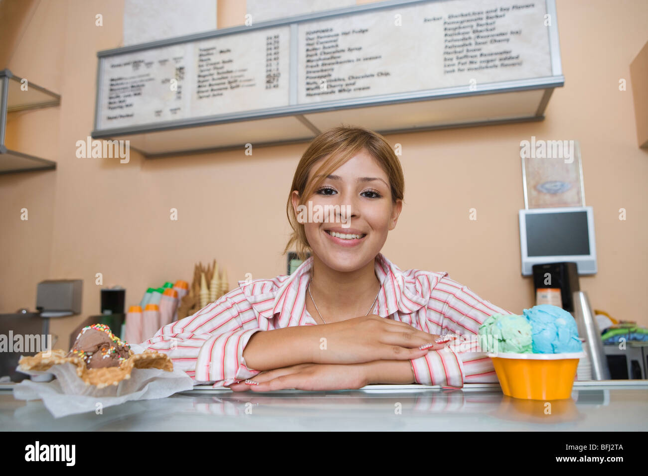 Portrait of young woman serving ice cream Stock Photo - Alamy