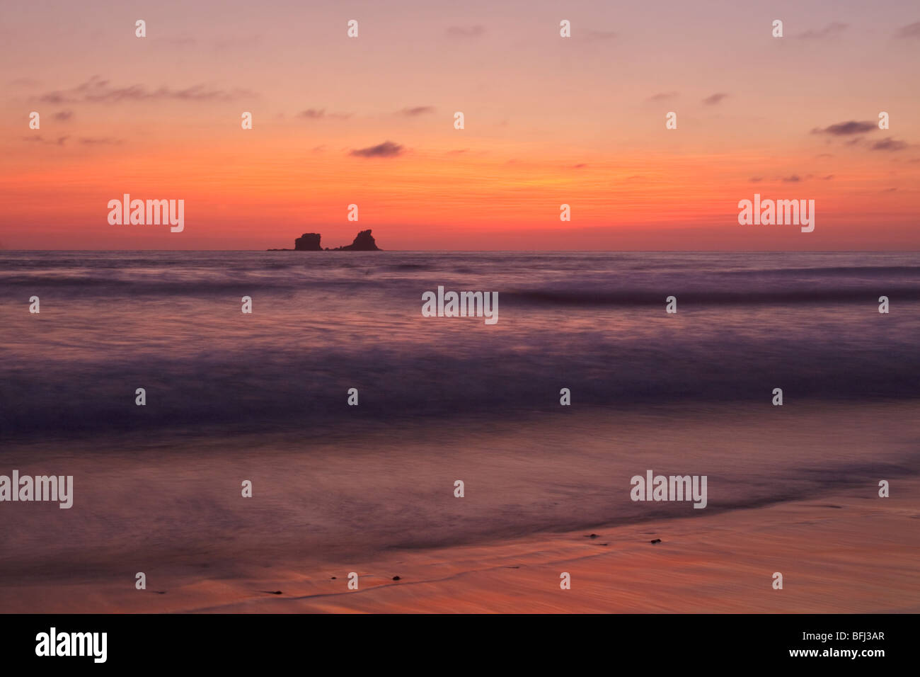 The sun sets over the Pacific Ocean along the coast of central Ecuador ...