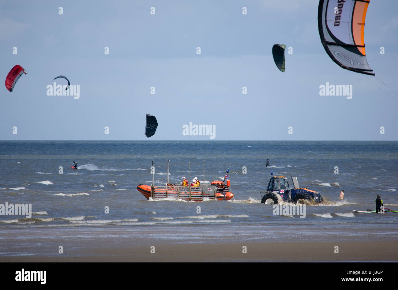 RNLI inshore life boat being launched by a tractor on the beach at ...