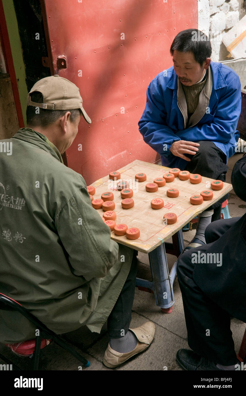 two chinese men playing a board game in the back streets of lhasa Stock ...