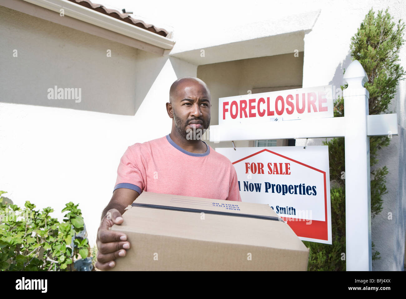 Sad mid adult man moving out of house Stock Photo - Alamy