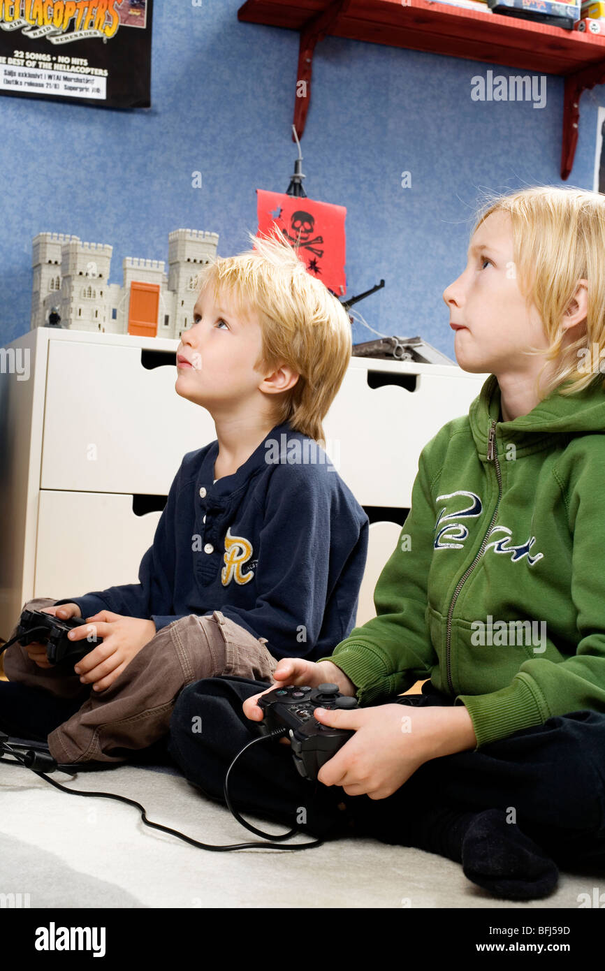 Two Scandinavian boys playing video games, Sweden Stock Photo - Alamy