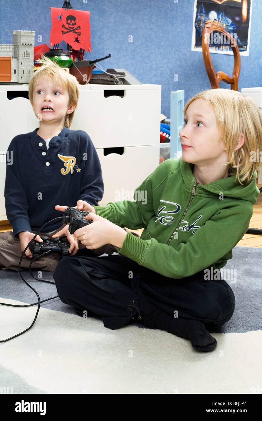 Two Scandinavian boys playing video games, Sweden Stock Photo - Alamy