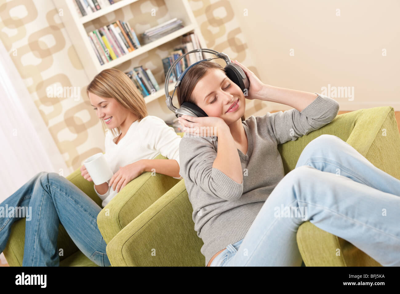 Students - Two female teenager relaxing in lounge having coffee and ... Students - Two female teenager relaxing in lounge having coffee and ...