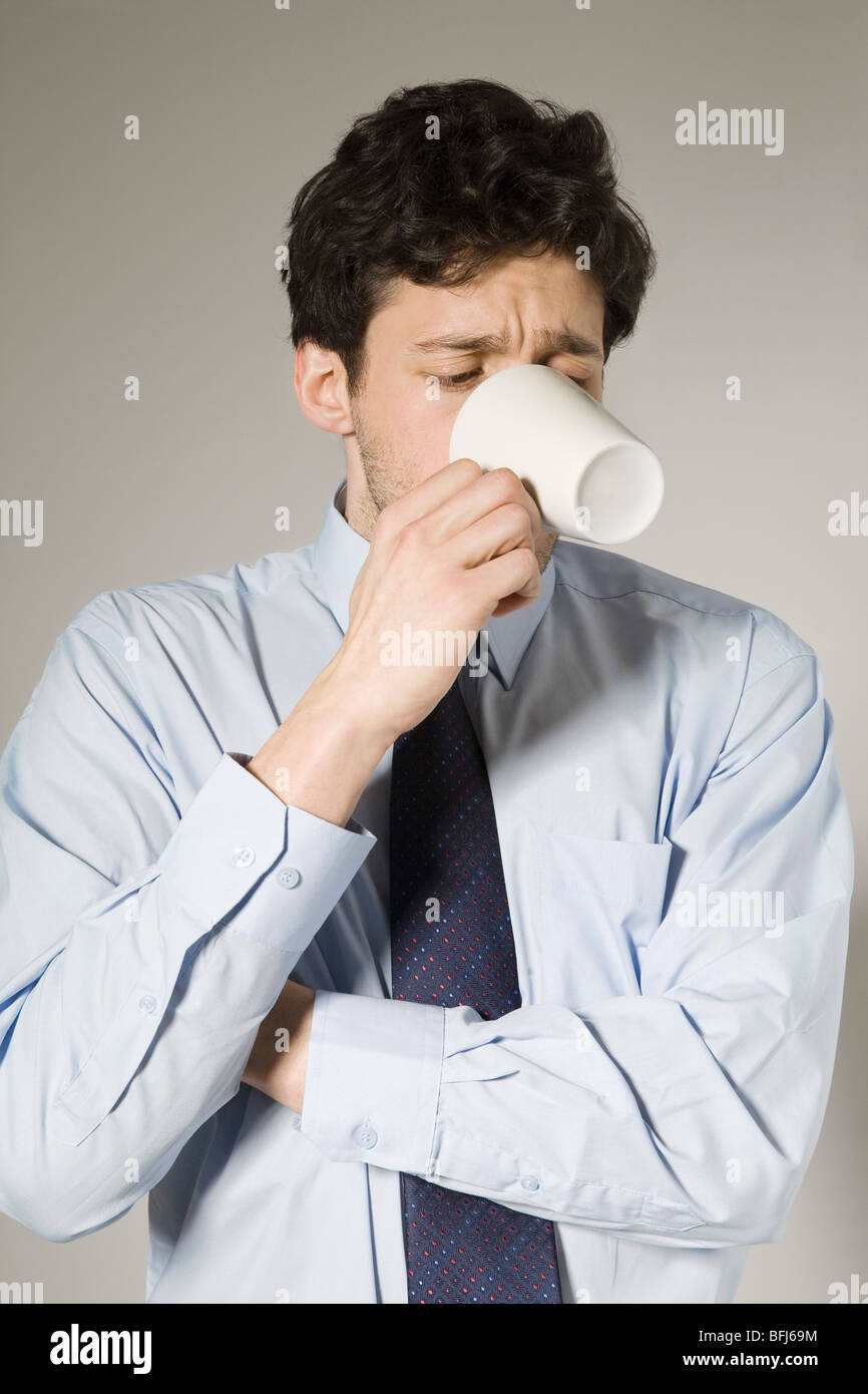 Young man drinking tea Stock Photo - Alamy