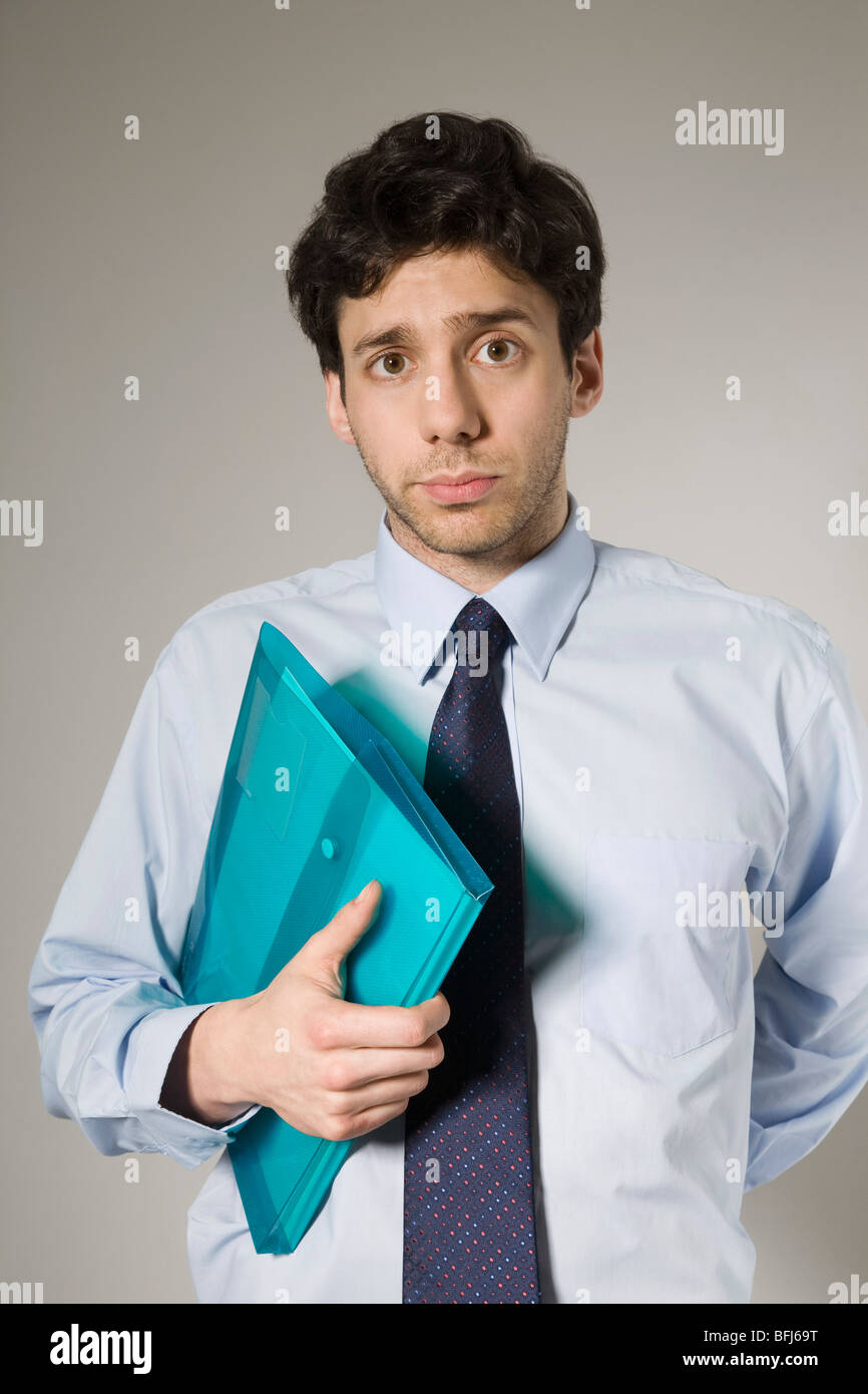 Young man holding documents Stock Photo - Alamy