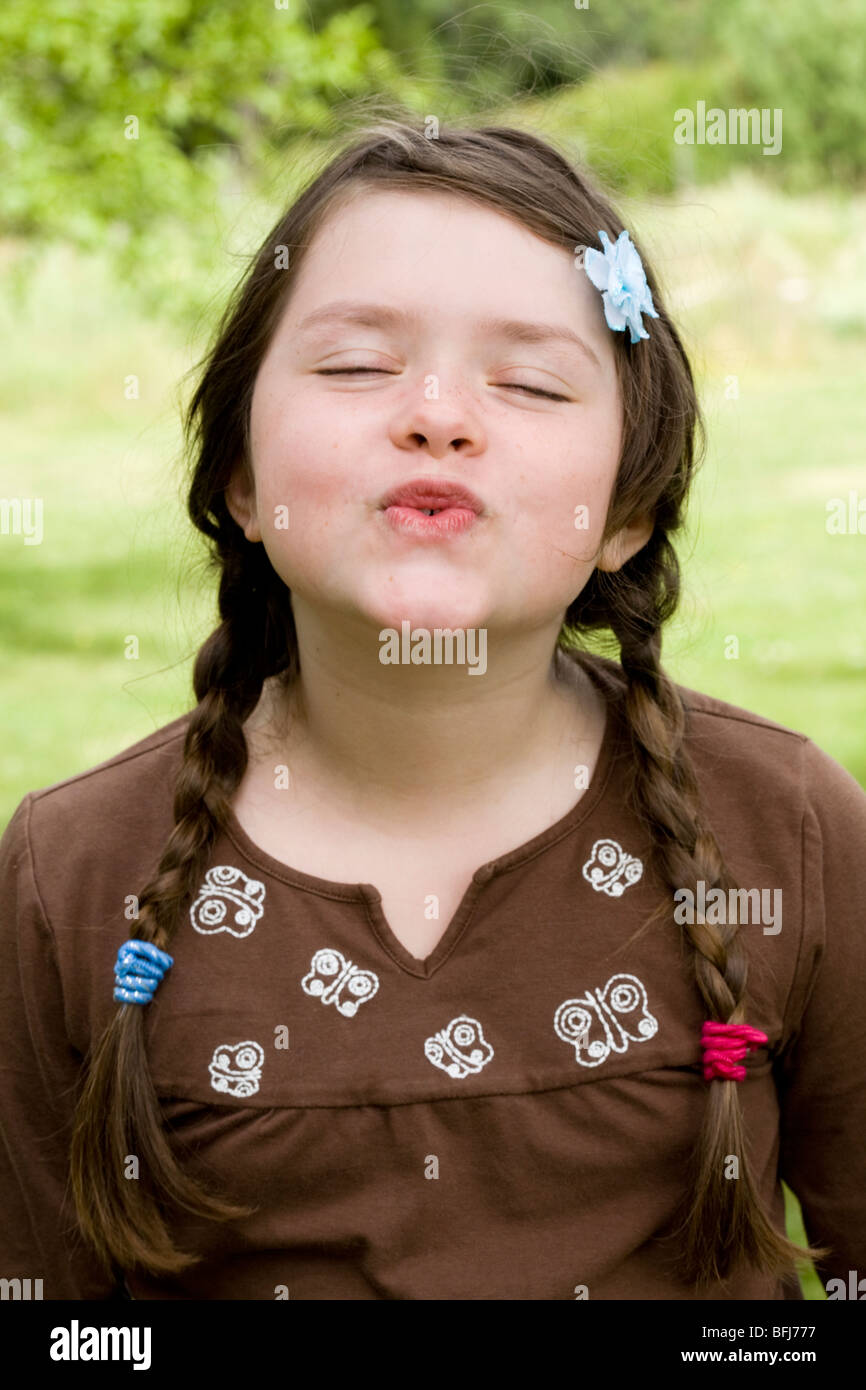 A girl with braids doing a kiss into the camera, Sweden Stock Photo - Alamy