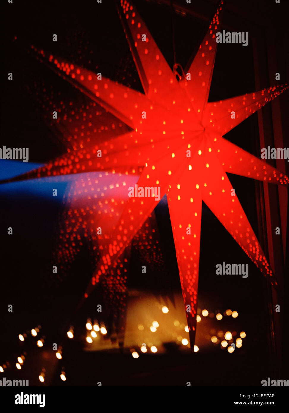 A red Advent star in a dark window, Sweden Stock Photo - Alamy