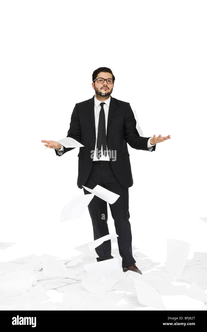 Businessman throwing paper around him Stock Photo - Alamy