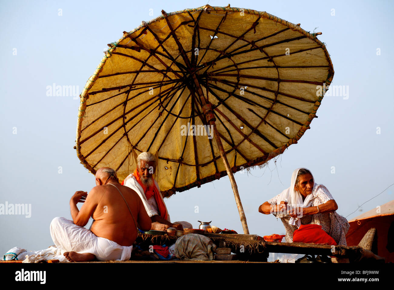 indians at varanasi sitting under umbrella Stock Photo - Alamy