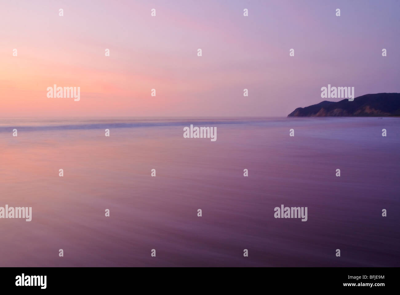 The sun sets over the Pacific Ocean along the coast of central Ecuador ...