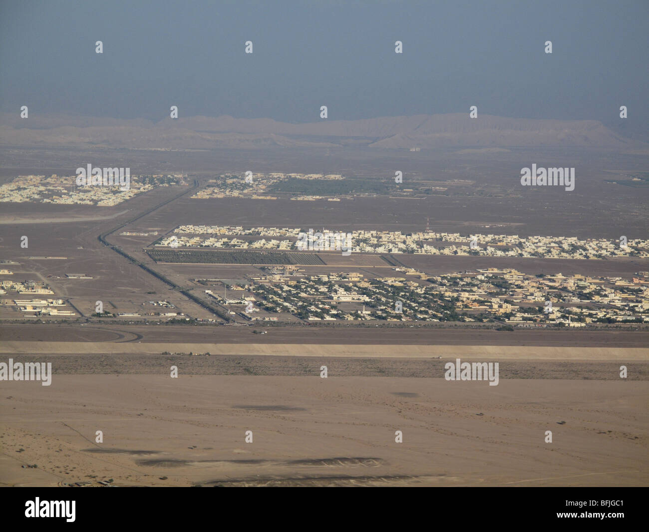 View from Jebel Hafeet mountain of single storey buildings and town in ...