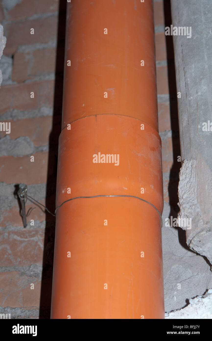 Vertical gutter in orange PVC Stock Photo - Alamy