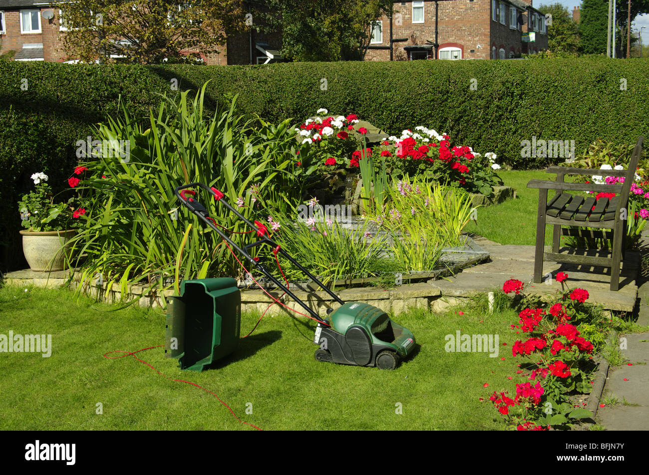 Abandoned lawnmower in garden Stock Photo - Alamy