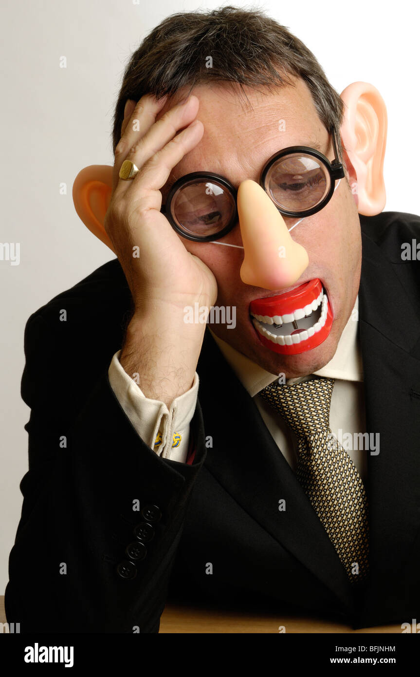 man in disguise leaning head on hand Stock Photo - Alamy
