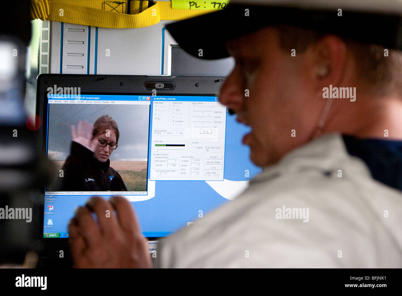 A weather channel production assistant assists reporter Katy Tur with a ...