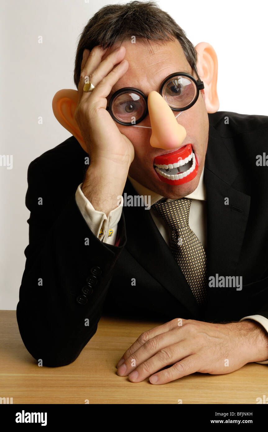 man in disguise leaning head on hand Stock Photo - Alamy