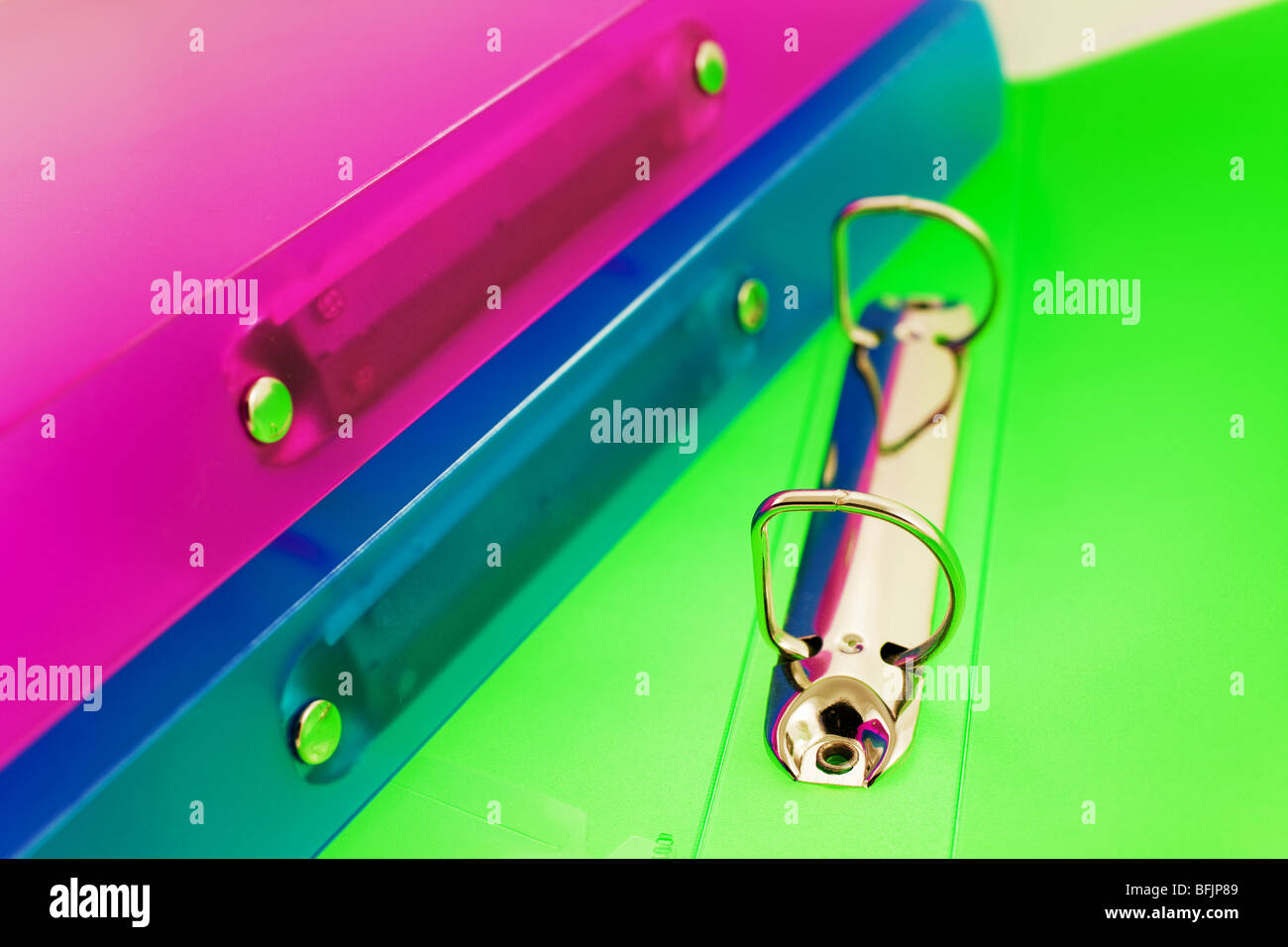 three multicolored folders, one folder is open. Closeup Stock Photo - Alamy