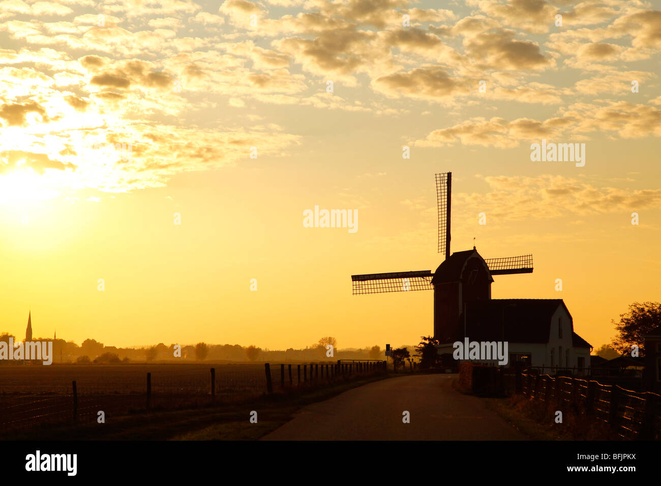Traditional windmill on river levy along Maas River, The Netherlands ...