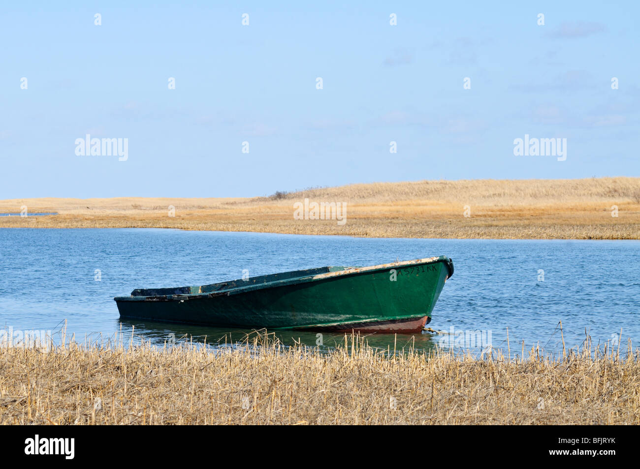 Chatham Cape Cod scenic with old wooden green boat, beach grass, water ...