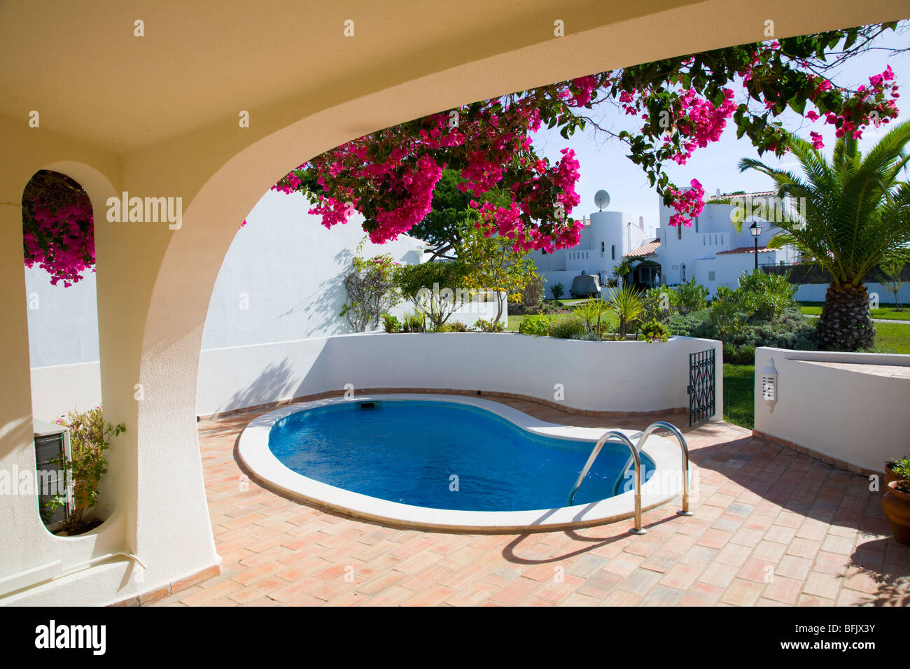 View from villa overlooking a kidney shaped swimming pool Stock Photo ...