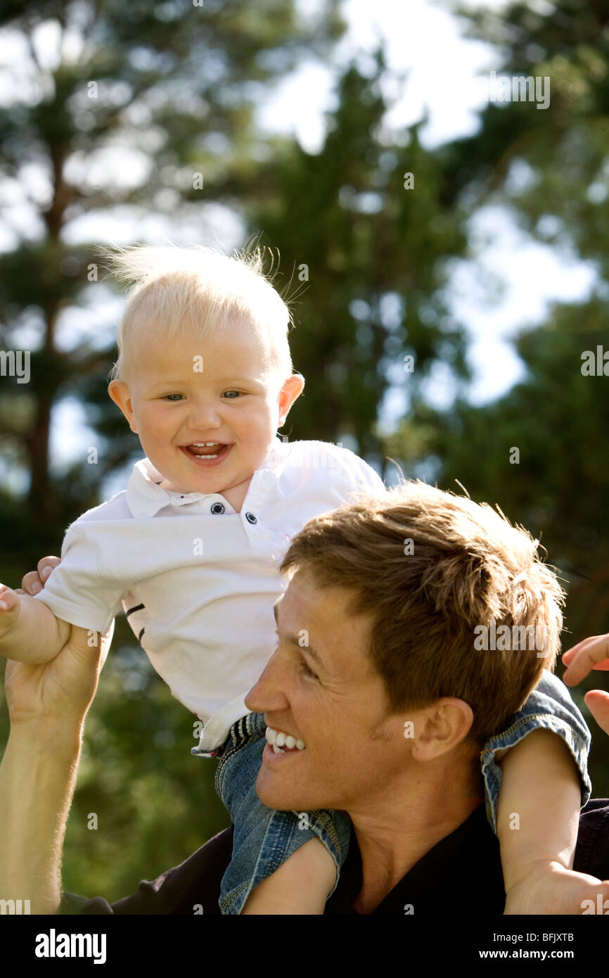 Father carrying a boy on his shoulders, Sweden Stock Photo - Alamy