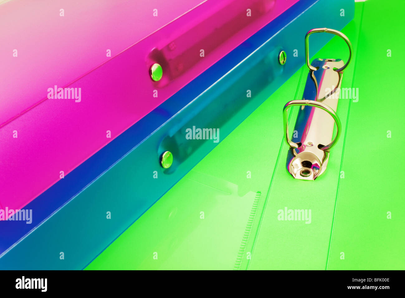 three multicolored folders, one folder is open. Closeup Stock Photo - Alamy