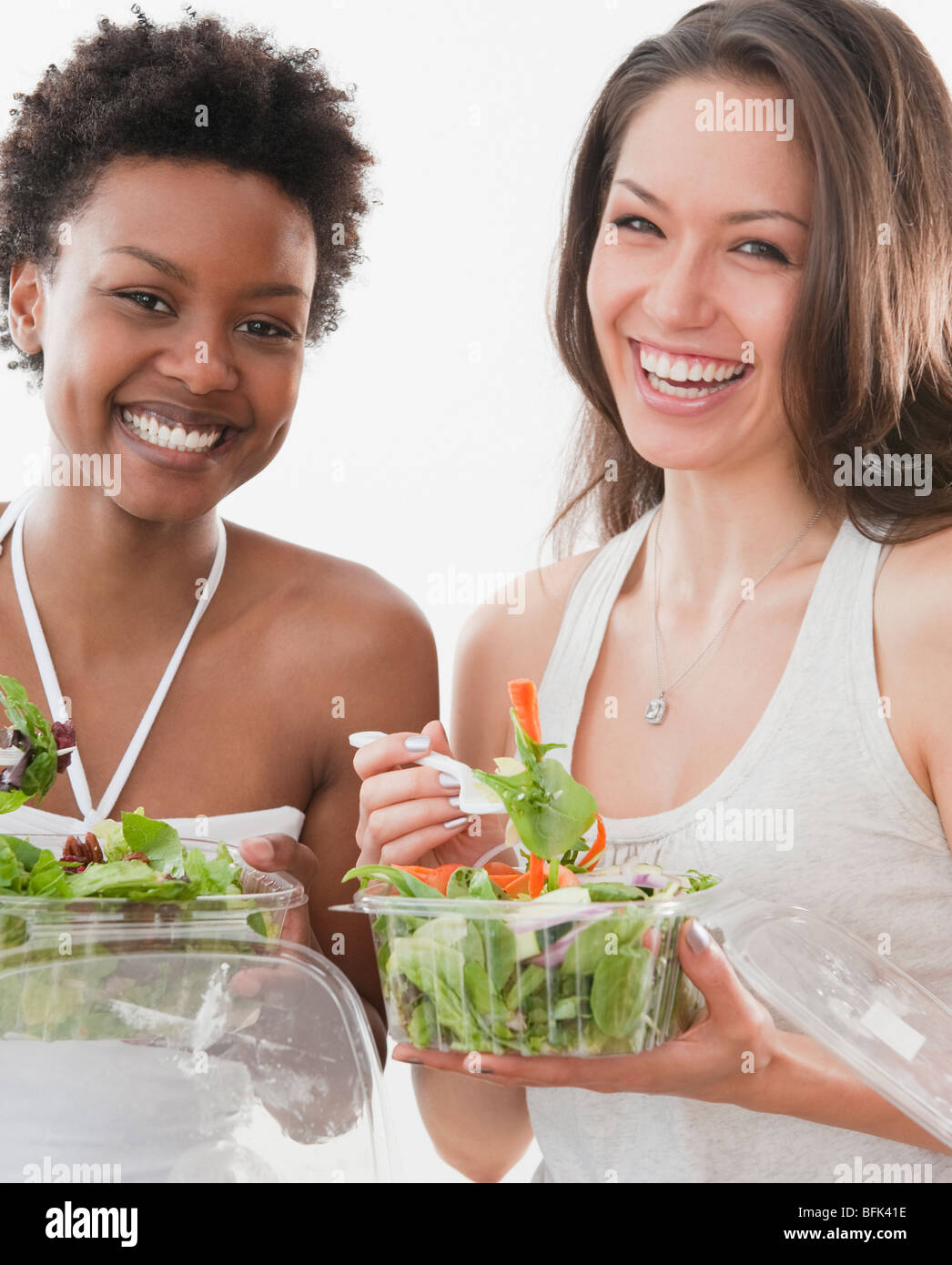 Friends eating salad Stock Photo - Alamy