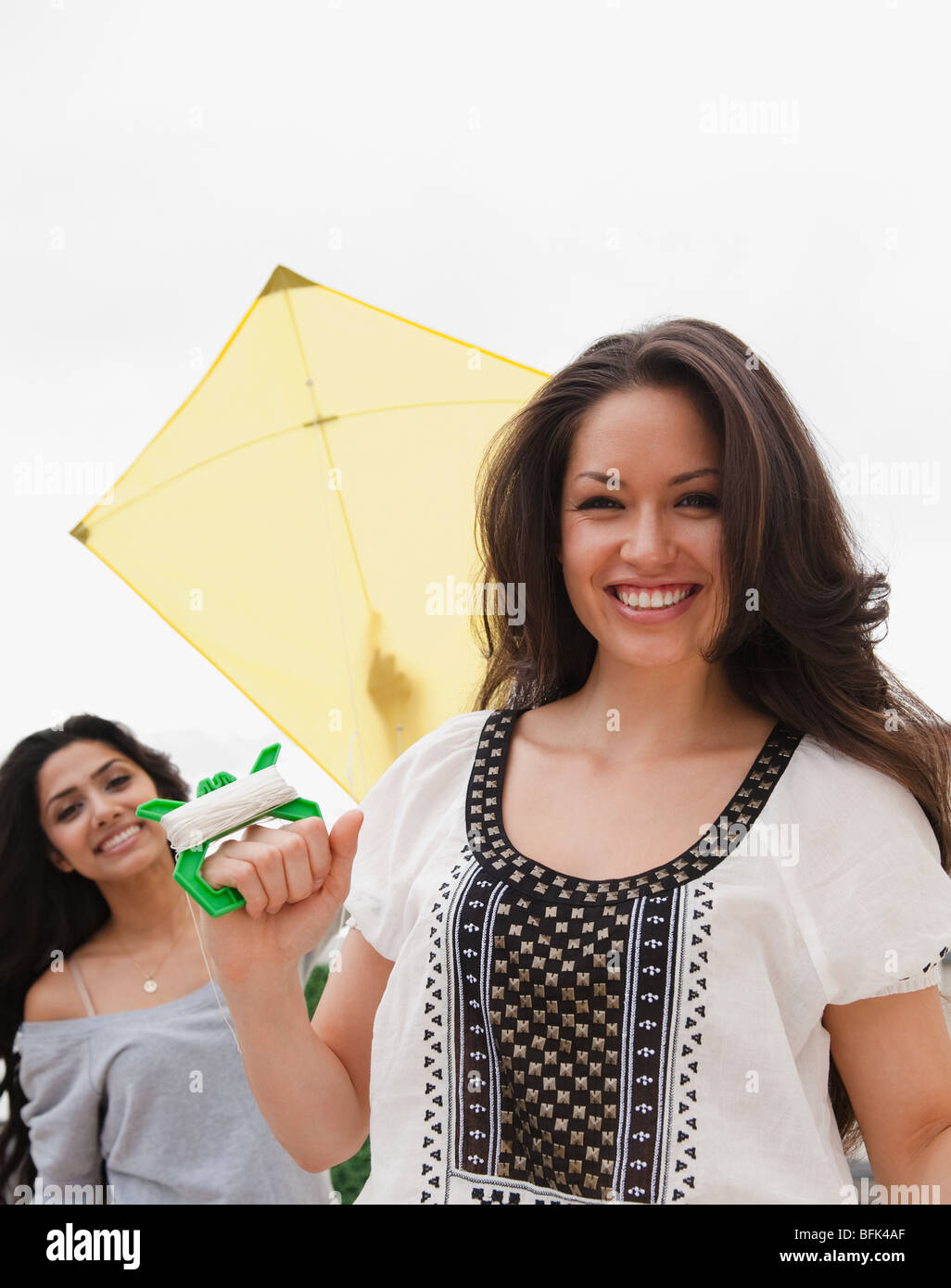 Friends flying kite Stock Photo - Alamy
