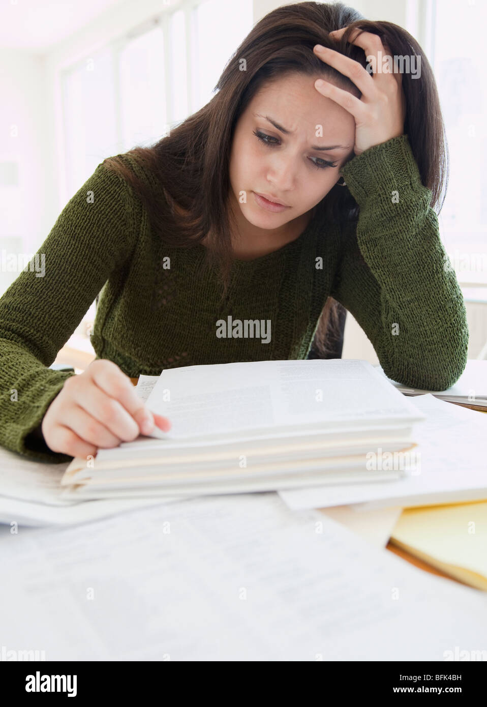Mixed race woman frustrated over paperwork Stock Photo - Alamy
