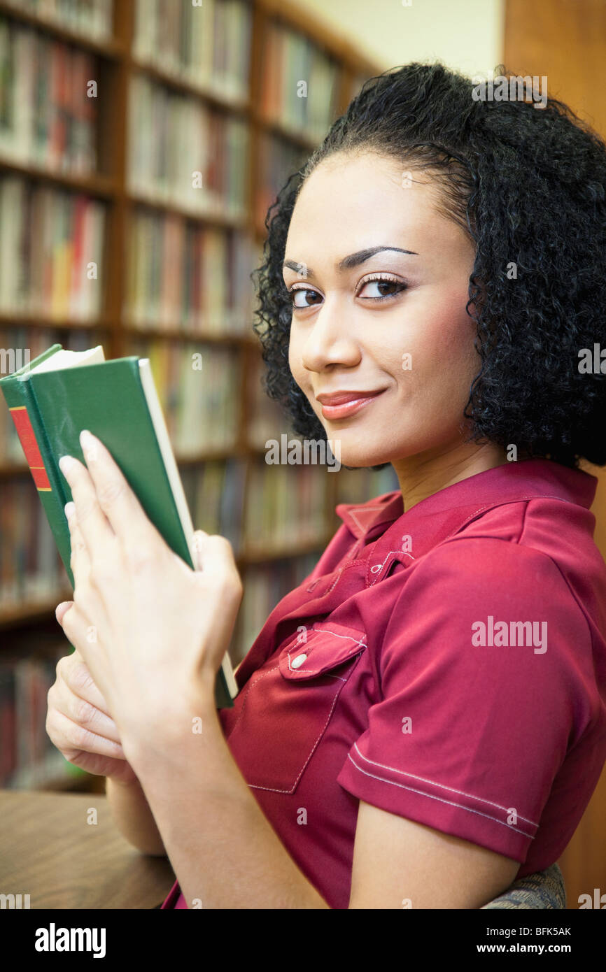 African woman reading book in library Stock Photo - Alamy