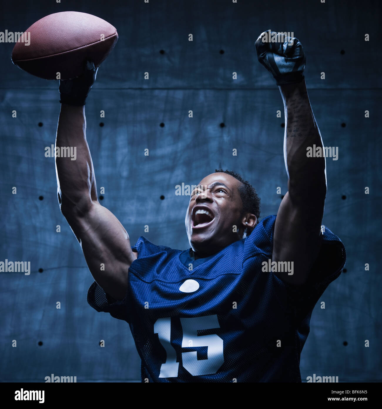 African football player cheering with arms raised Stock Photo - Alamy
