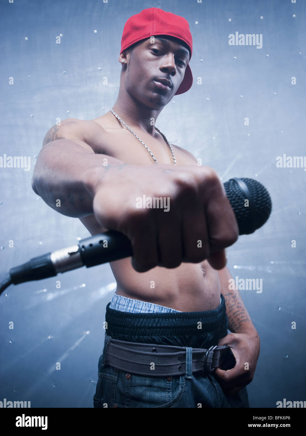 Back lit African singer holding microphone Stock Photo - Alamy