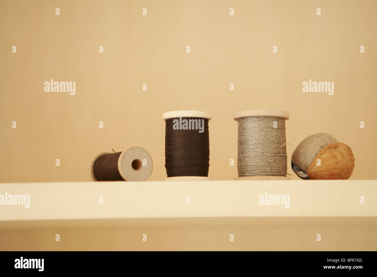 Spool of threads and pin cushion Stock Photo - Alamy