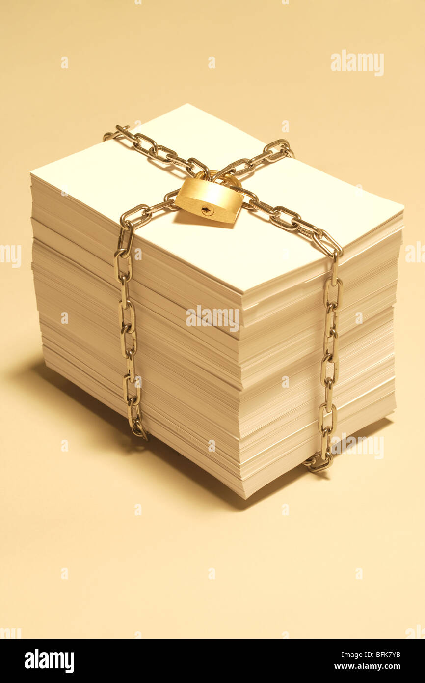 Stack of paper with lock and chain Stock Photo - Alamy