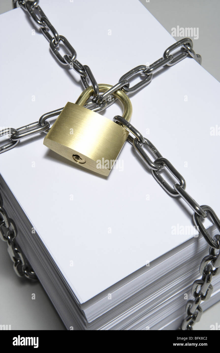 Stack of papers wrapped in chain close up white background Stock Photo ...