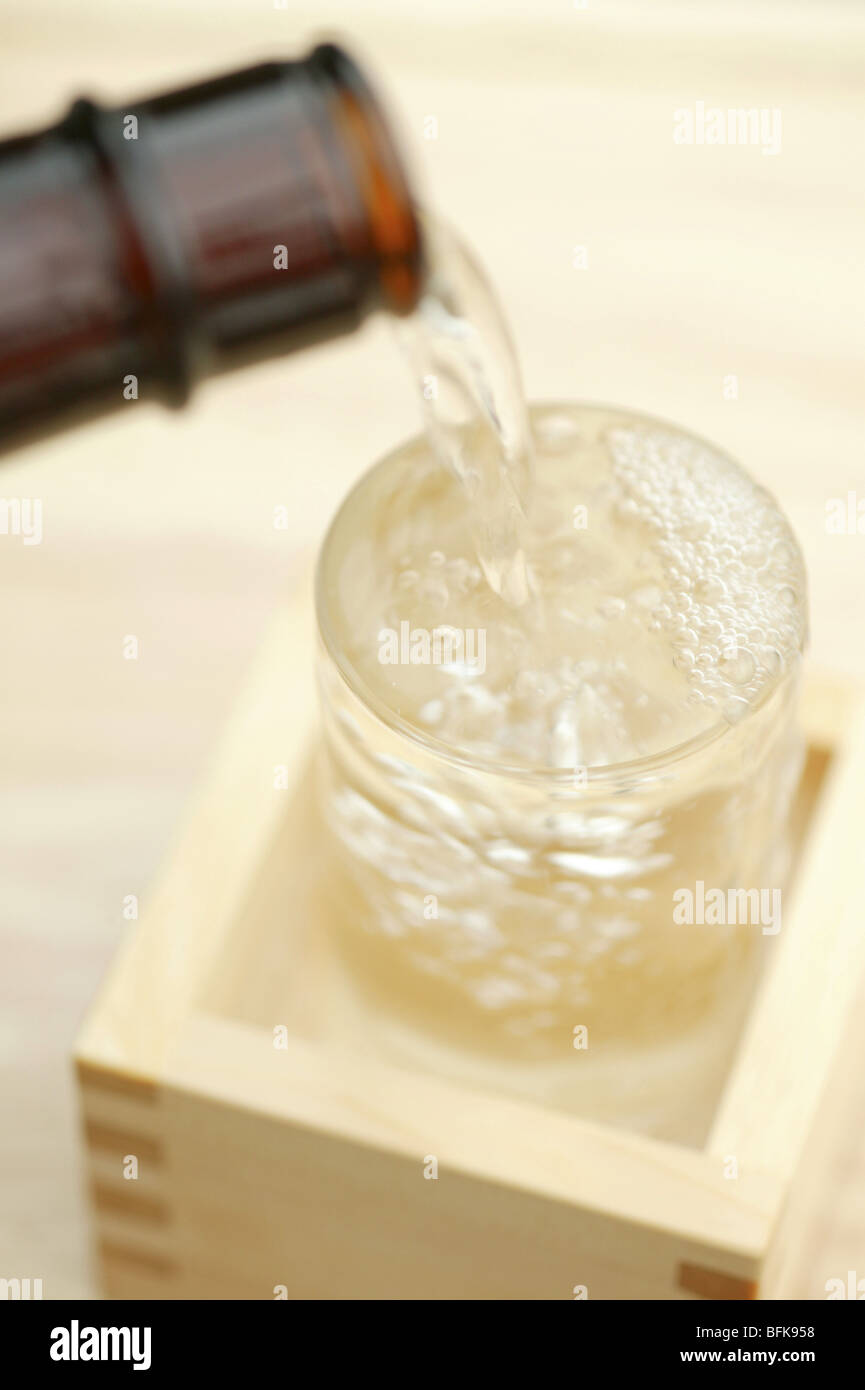 Sake pouring into glass Stock Photo - Alamy