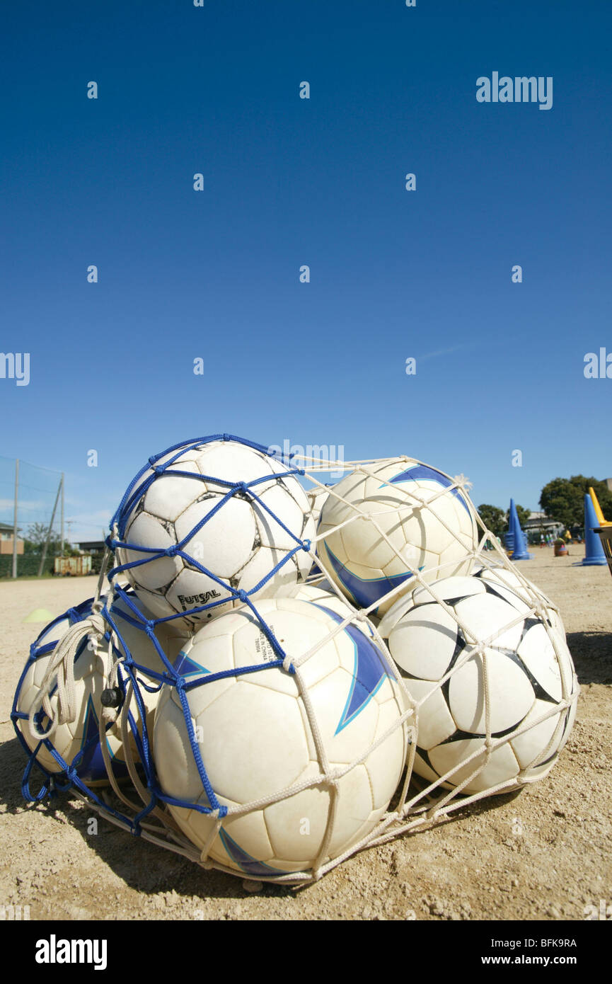 Soccer balls in a net Stock Photo - Alamy