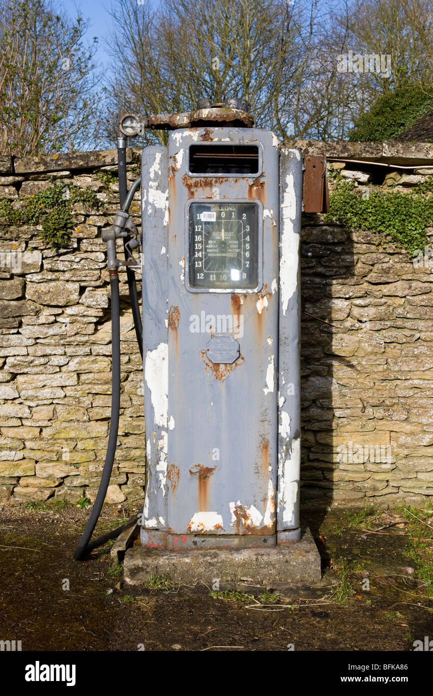 A vintage rusty fuel pump against Cotswold stone wall Stock Photo - Alamy