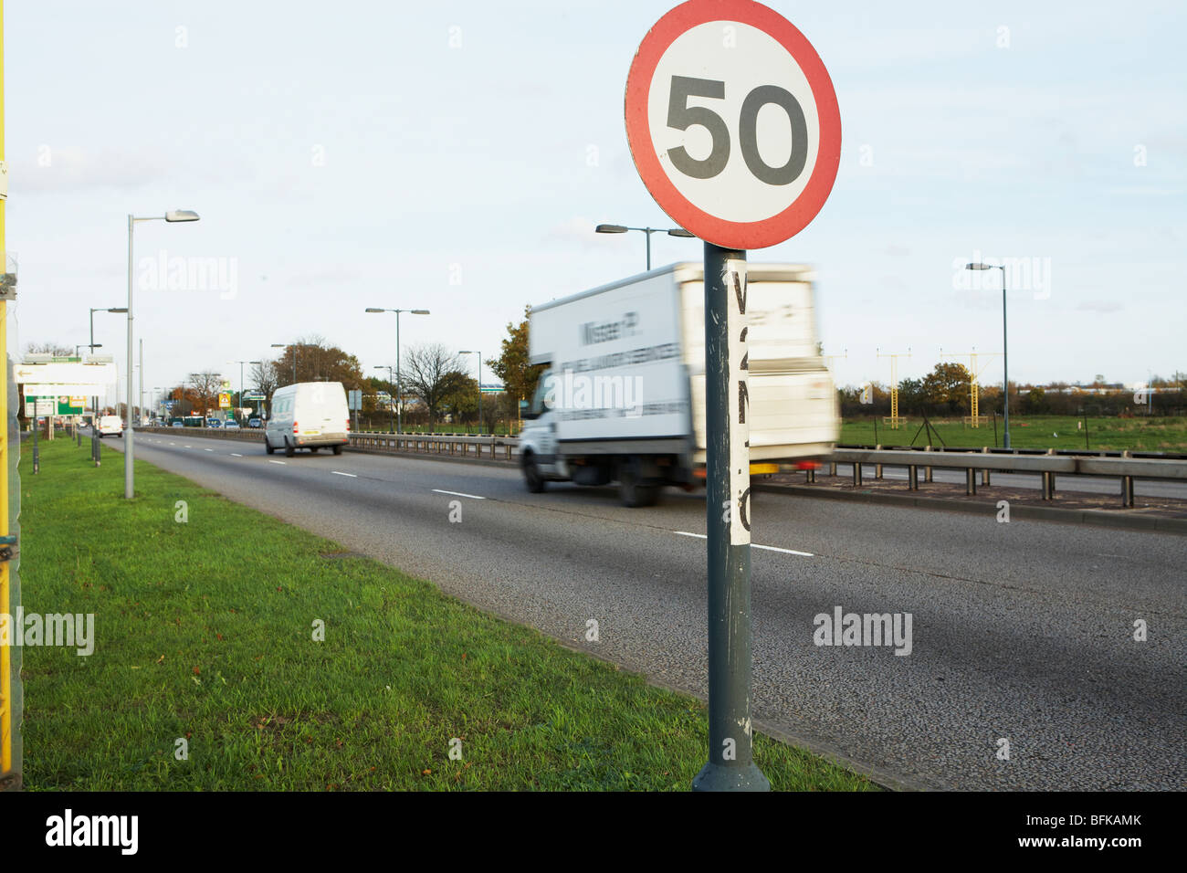 50mph speed limit sign with cars passing Stock Photo - Alamy