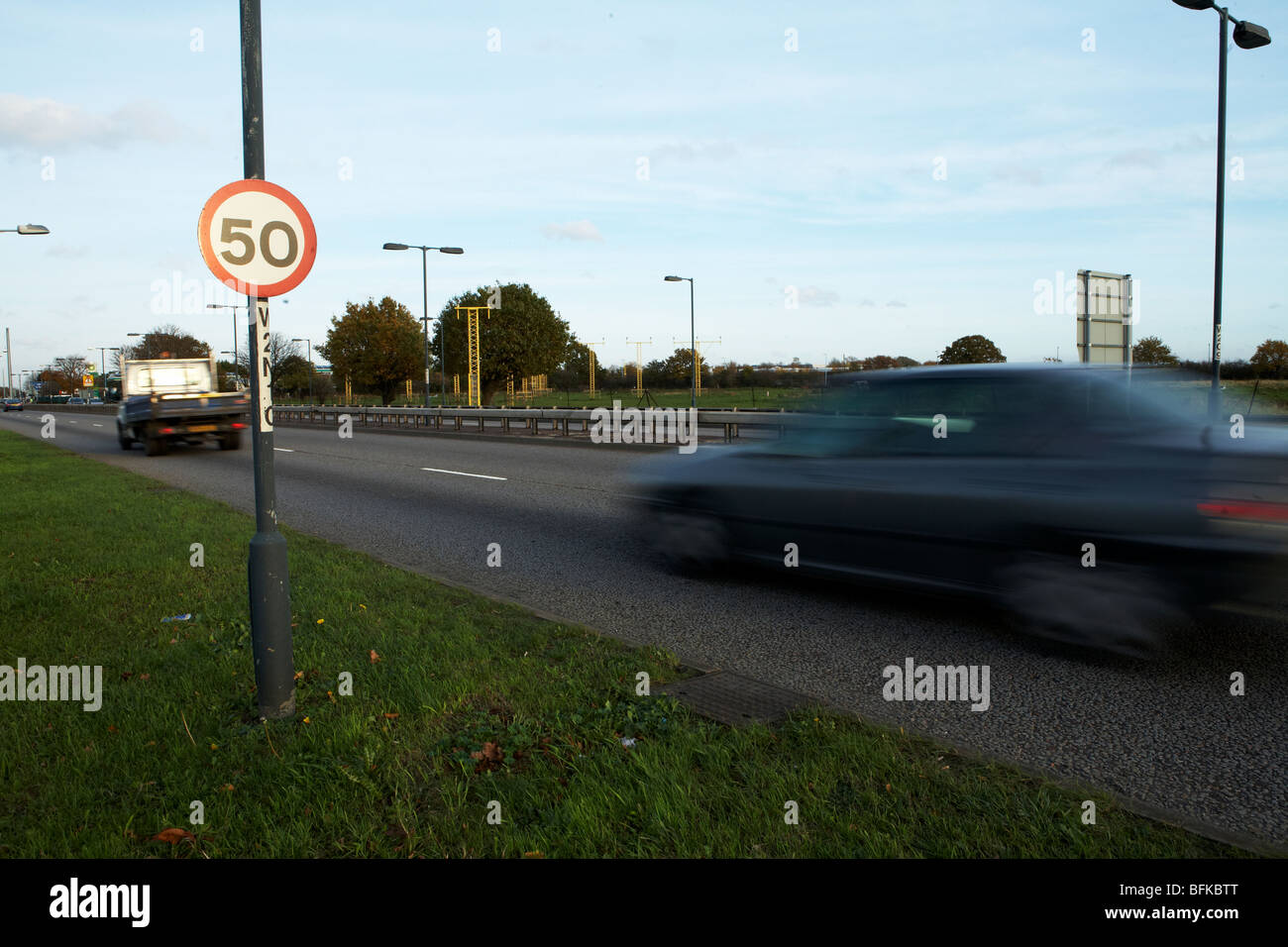 50mph speed limit sign with cars passing Stock Photo - Alamy