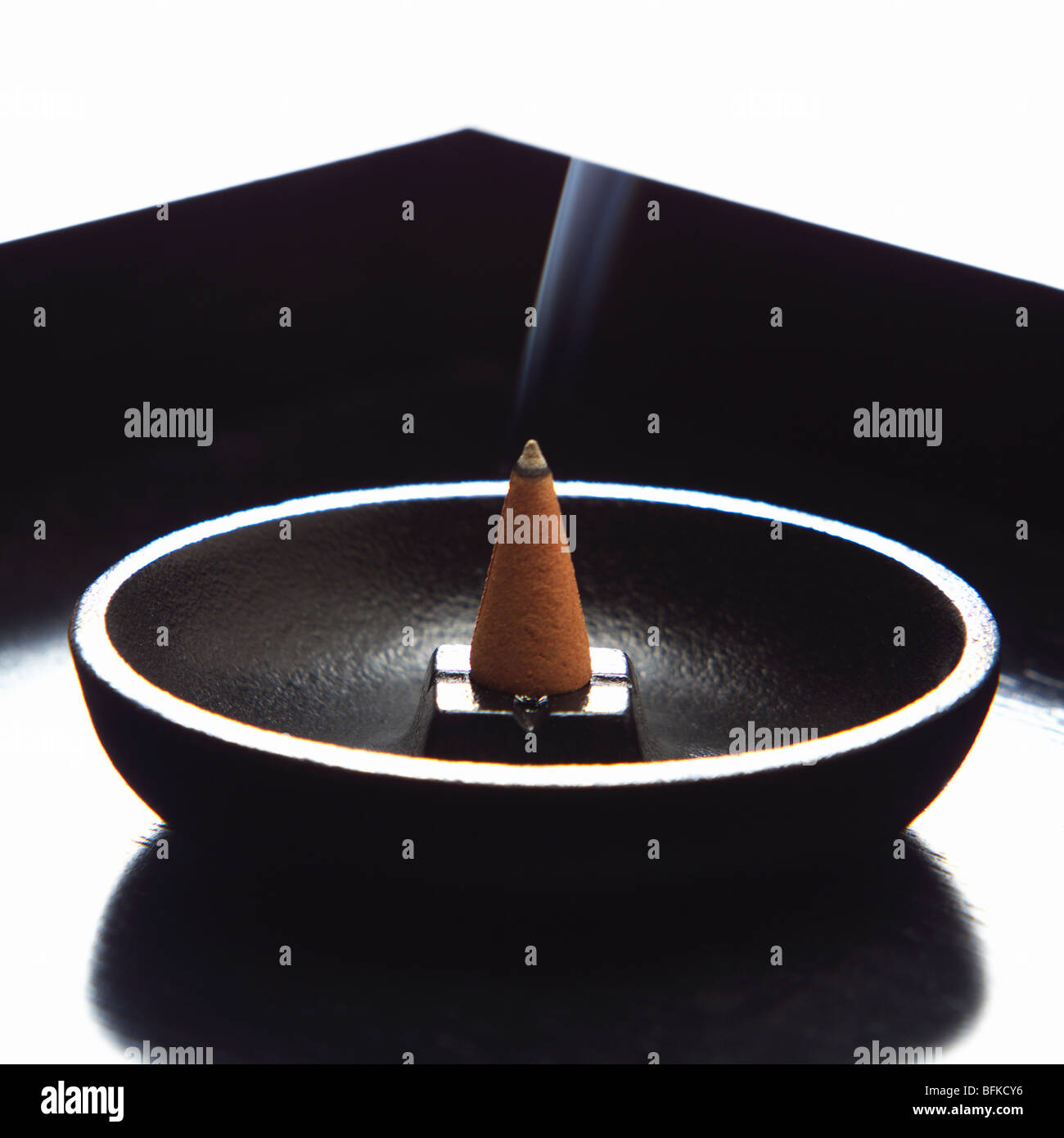 Cone of incense white background Stock Photo - Alamy