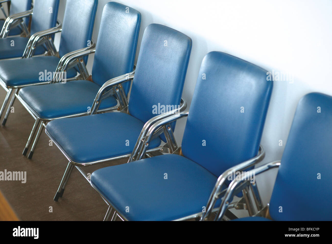 Chairs placed in line Stock Photo - Alamy