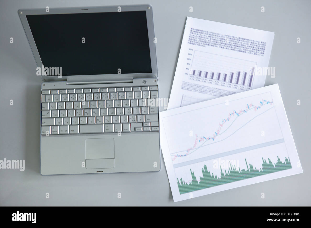 Rising graphs on papers and laptop white background Stock Photo - Alamy