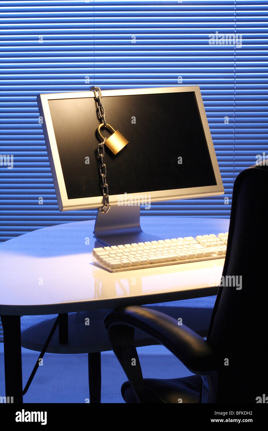 Computer wrapped in chain Stock Photo - Alamy